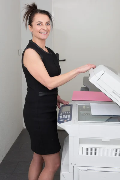Woman at work, with a copy machine - Stock Image - Everypixel