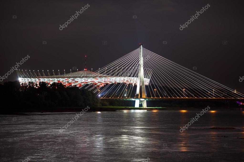 Night view of bridge and stadium in Warsaw — Stock Photo © castenoid ...
