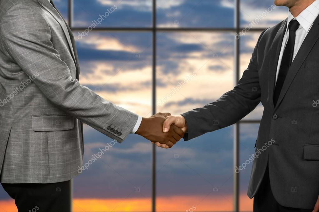 Politicians shake hands at sunset. — Stock Photo © Denisfilm #101872752