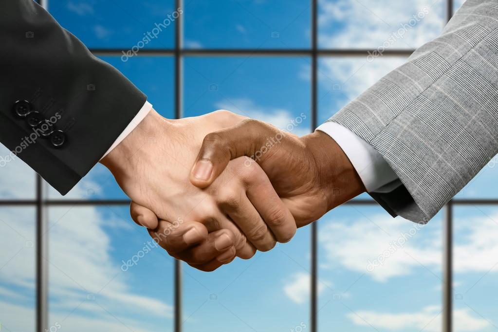 Business handshake on sky background. Stock Photo by ©Denisfilm 101873182