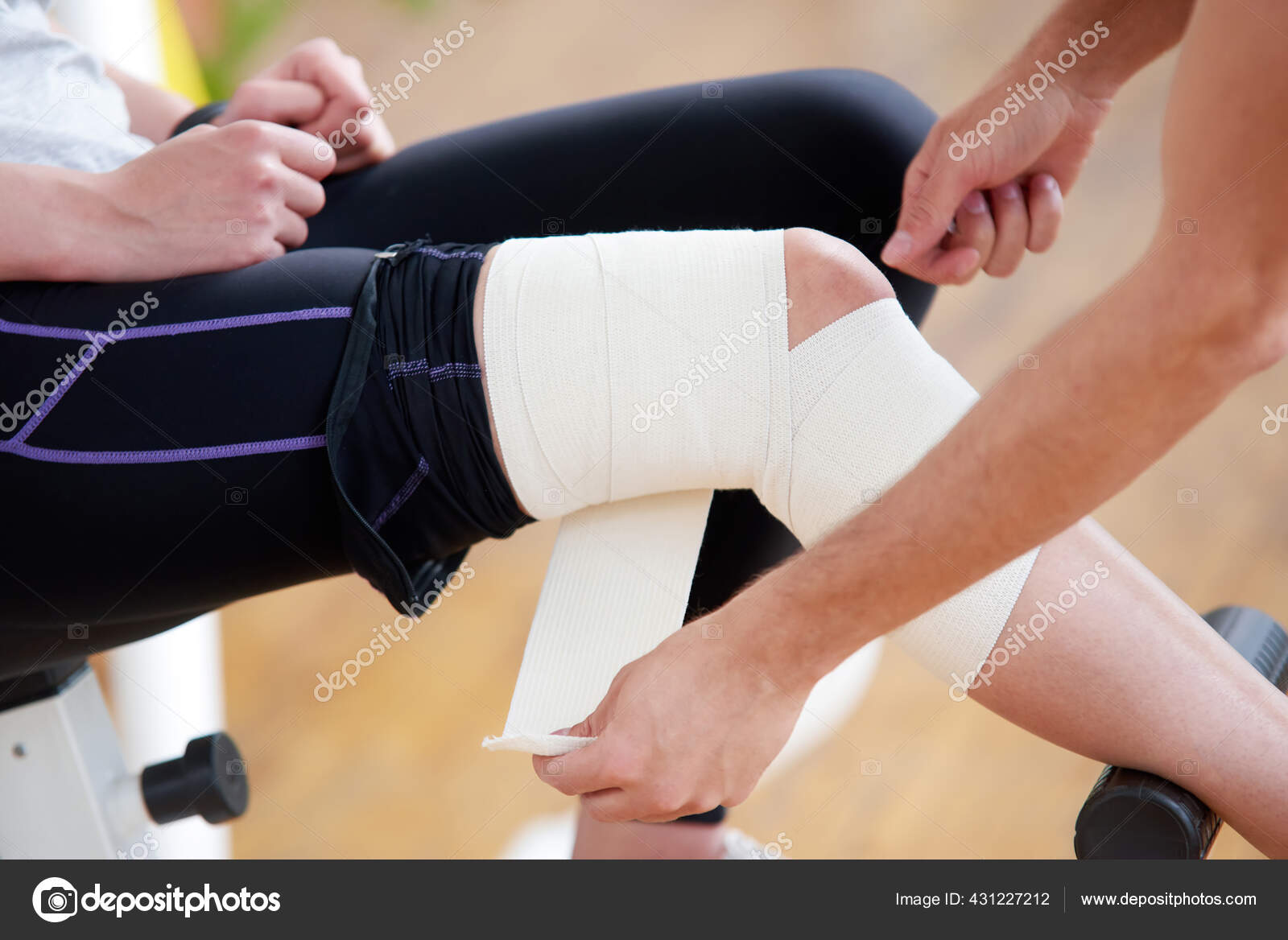 Applying a compression wrap for a sprained muscle. — Stock Photo ...