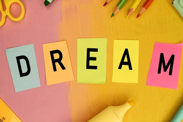 The letters that make up the word dream are written on colorful pieces ...