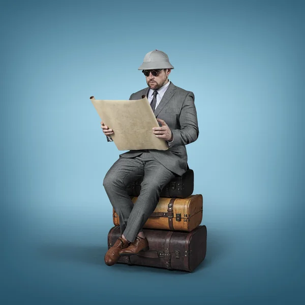 Explorer businessman lost in office and reading map - Stock Image ...