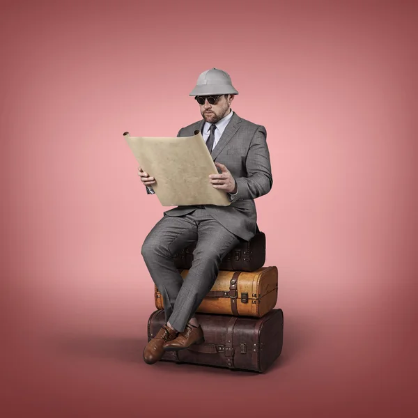 Explorer businessman lost in office and reading map - Stock Image ...