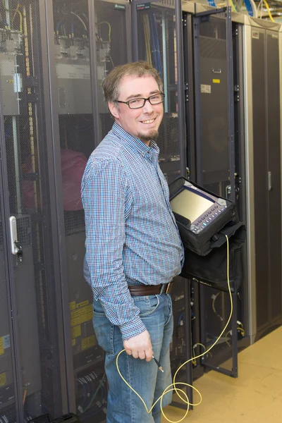 Engineer with optical tester in data center - Stock Image - Everypixel
