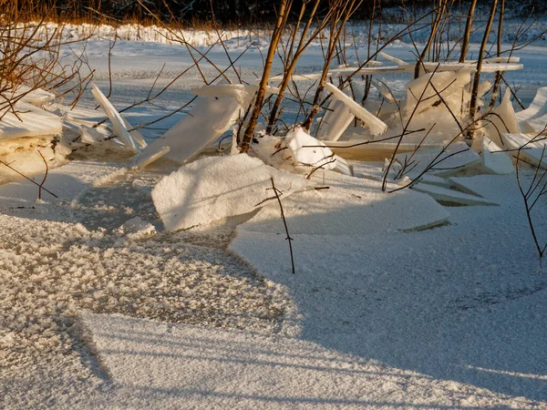 broken ice near the river bank in the cold. lower water levels break ...