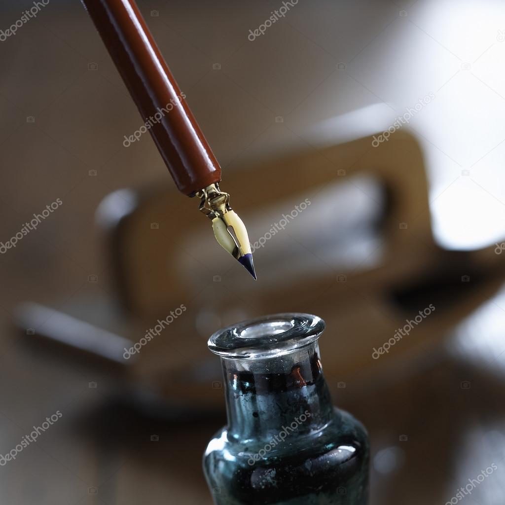 Ink with pen and ink blotter in background Stock Photo by ©Arrfoto 58868413