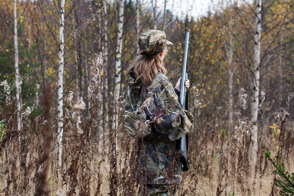 Woman hunter shooting in the forest — Stock Photo © RodimovPavel #87384590