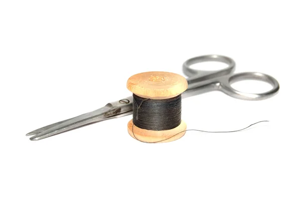 Thread bobbin and scissors Stock Photo by ©Garsya 8306167