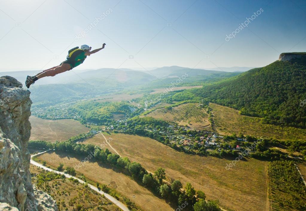 Base-jumper jumps from the cliff Stock Photo by ©sergeyonas 65922701