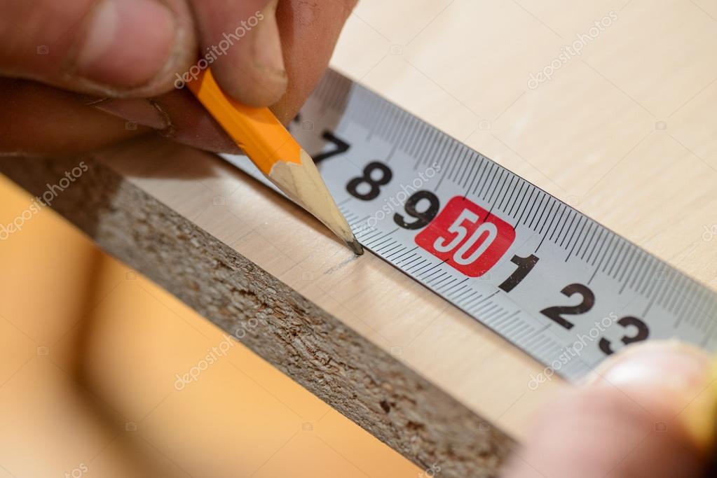 Furniture assembly. Master ruler measure the size of the furniture on ...