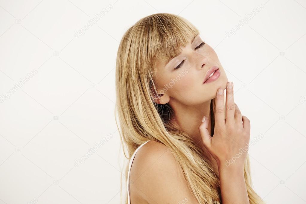 Beautiful woman touching face — Stock Photo © sanneberg #83700498