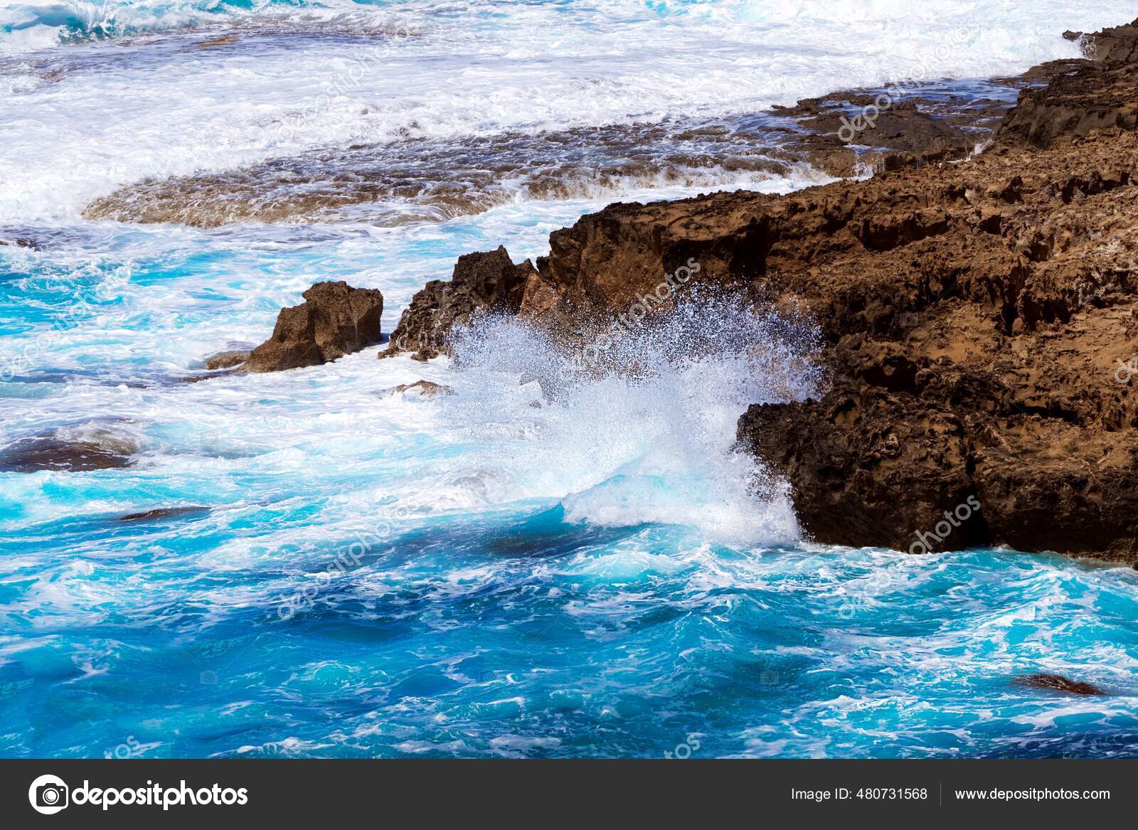 Ocean waves splash against beach with rocks background, Cliffs in the ...