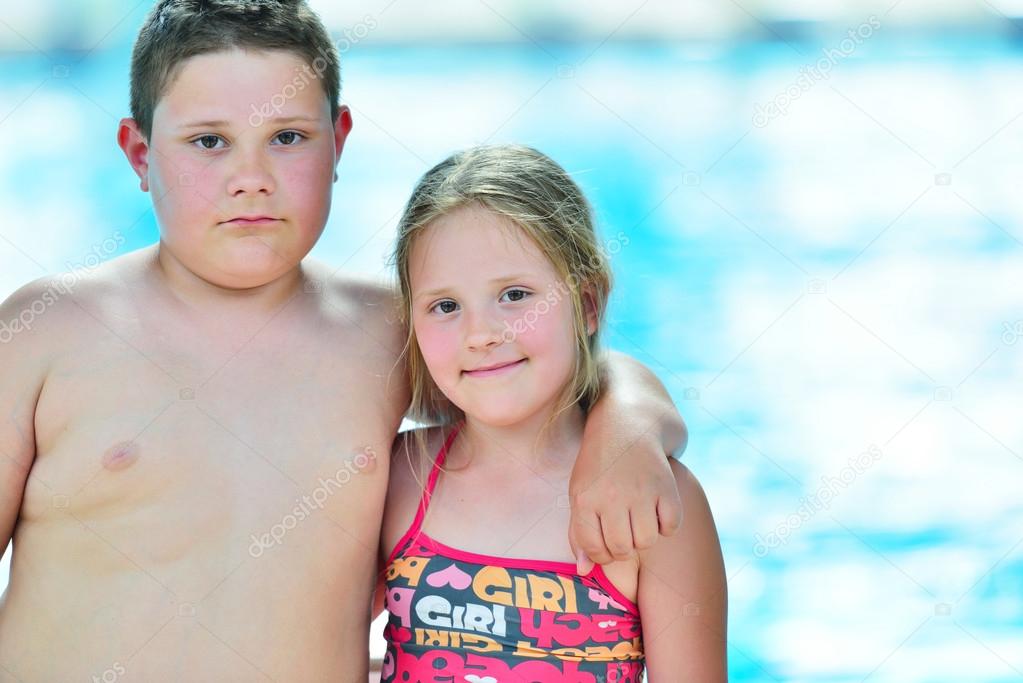 Two kids posing at pool Stock Photo by ©blicsejo 116877000
