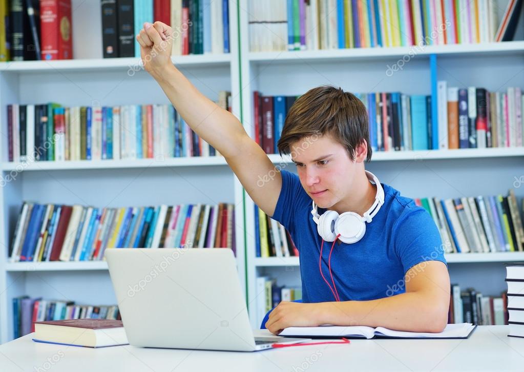 Male student working in a library — Stock Photo © blicsejo #87100378