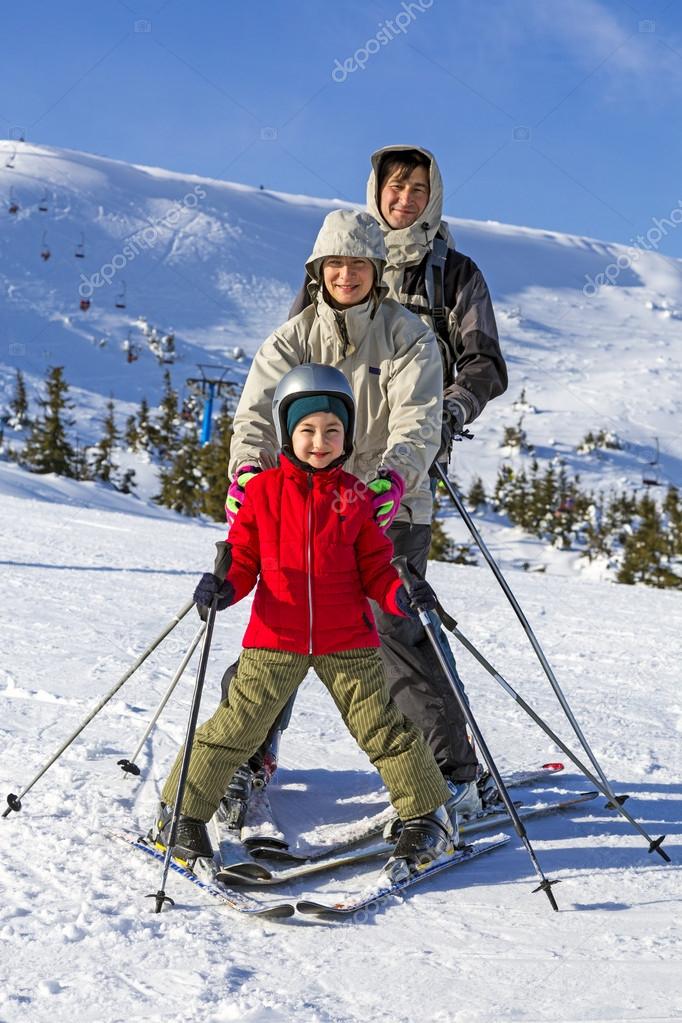 Family of three people learns skiing together — Stock Photo ...