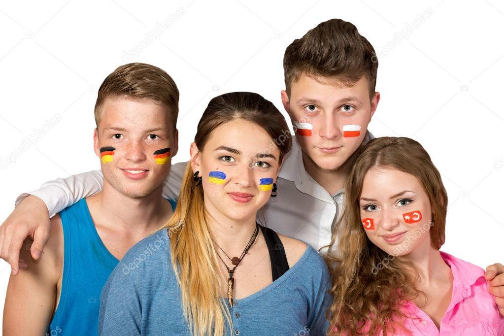 Four teenagers with flags drawn on the faces on white background ...
