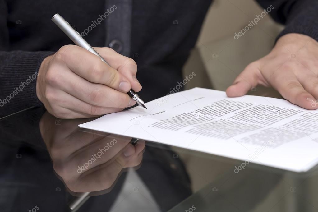 Hands of man signing formal paper Stock Photo by ©AlexBrylov 69377493