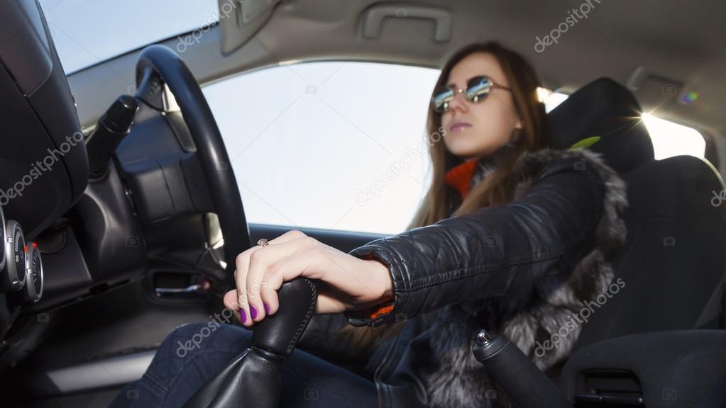Confident female driver Stock Photo by ©AlexBrylov 71176027