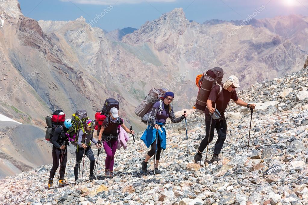 Group of Hikers Walking on Deserted Rocky Terrain Stock Photo by ...