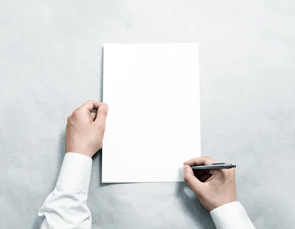 Hand holding blank agreement mockup and signing it. - Stock Image ...