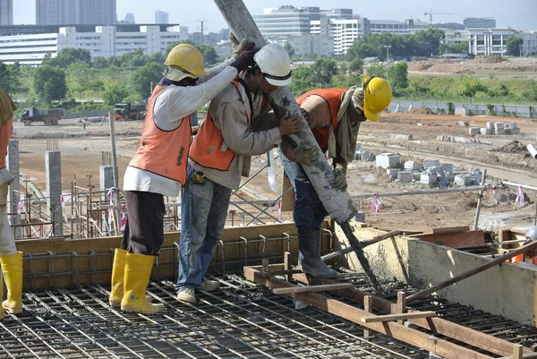 Construction Workers casting concrete using concrete hose – Stock ...