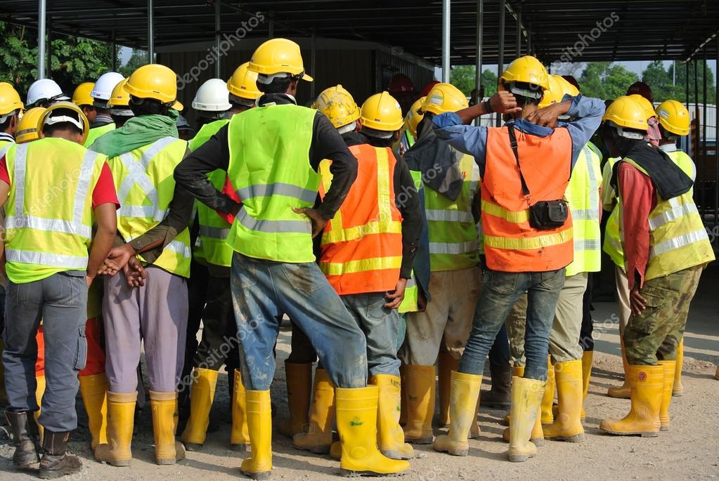 Group of construction workers assemble at the open space. — Stock Photo ...
