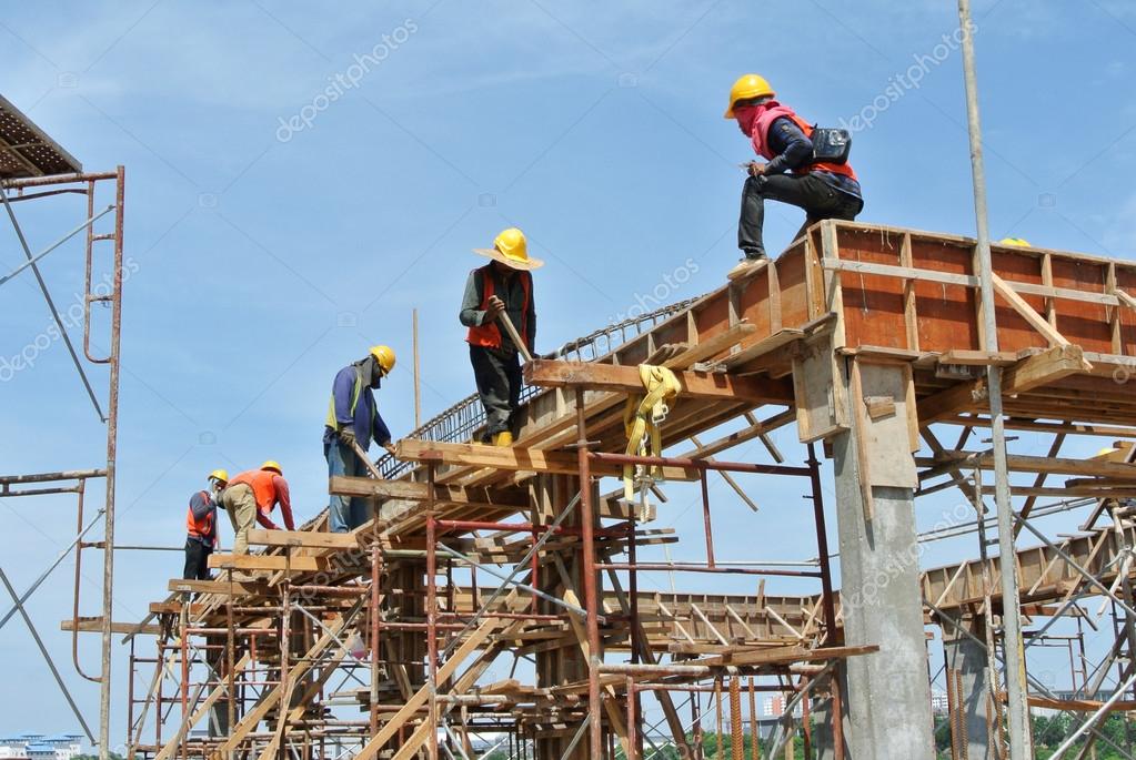 Construction workers fabricating beam reinforcement bar – Stock ...
