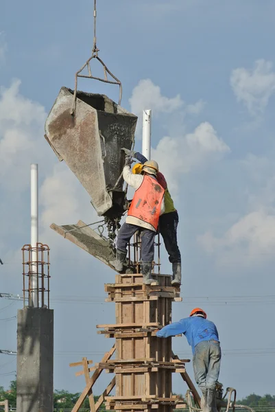 Group of construction workers casting column - Stock Image - Everypixel