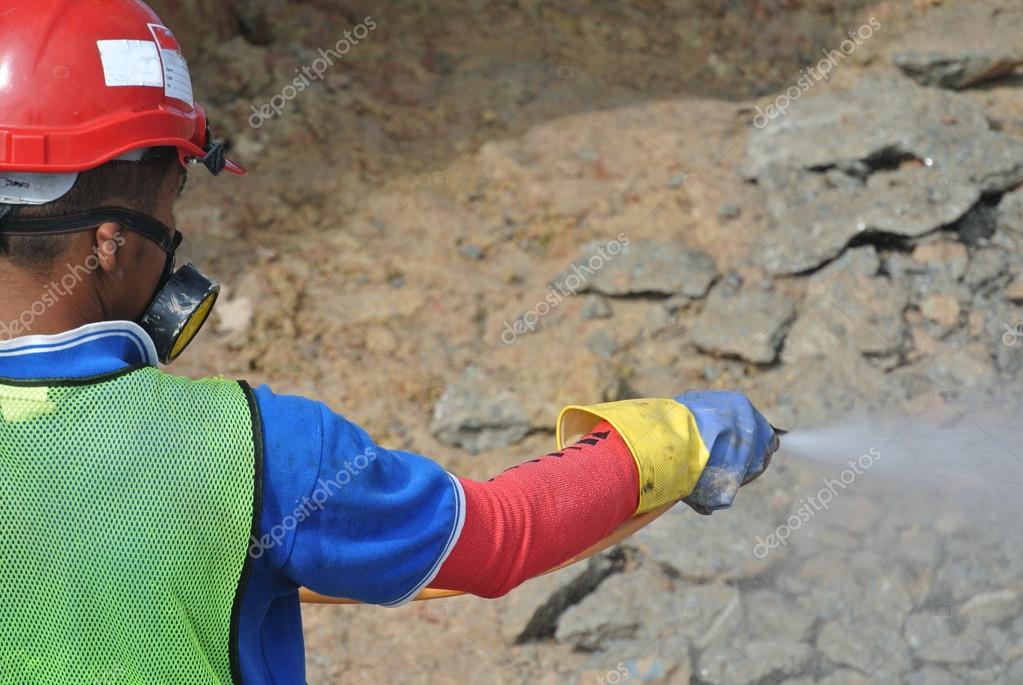 Construction workers spraying the anti termite chemical treatment to ...