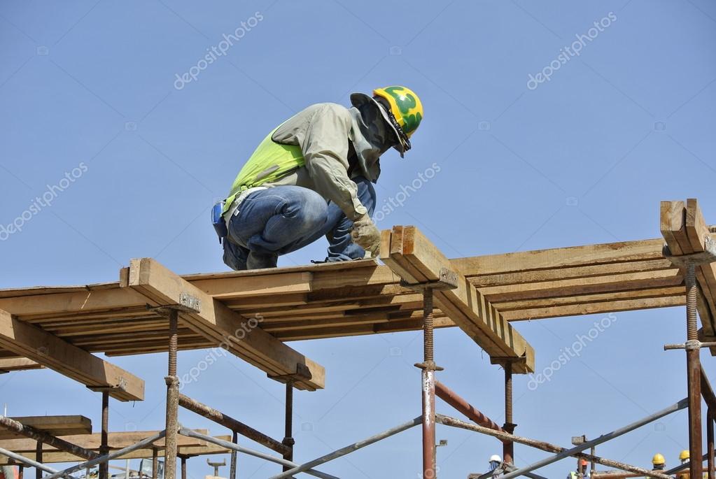Construction workers installing timber formwork Stock Photo by ...