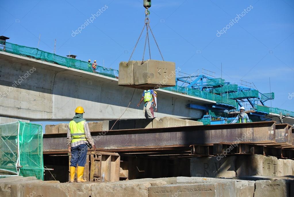 Construction workers stacking the maintain load test block at the ...