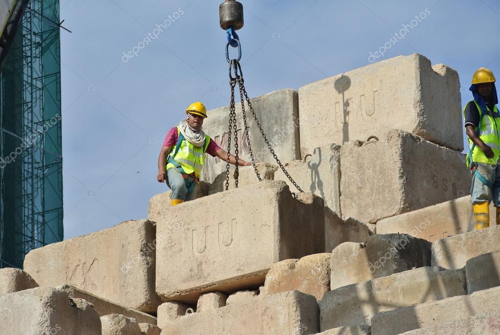 Construction workers stacking the maintain load test block at the ...