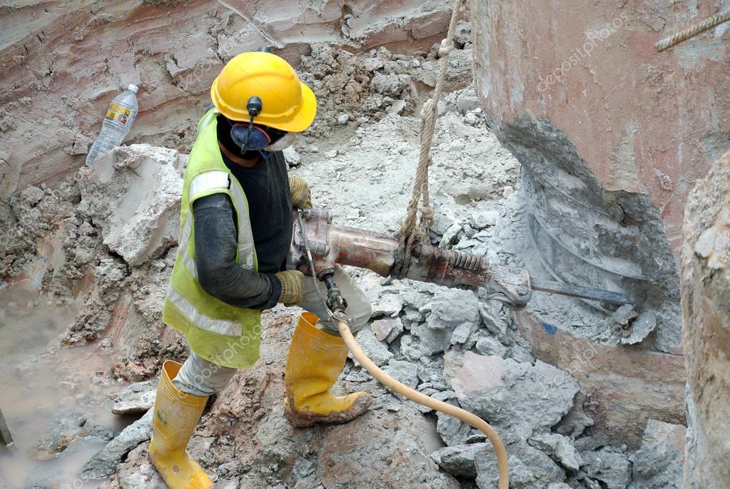 Trabajadores de la construcción que utilizan hacker móvil de hormigón ...