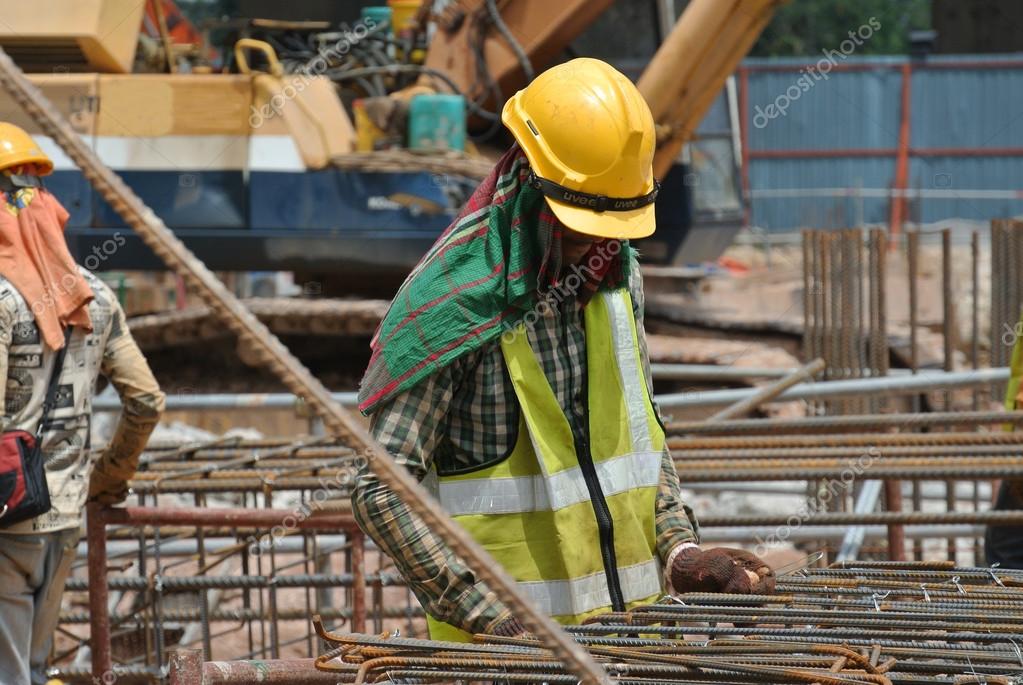 Group of construction workers fabricating pile cap steel reinforcement ...