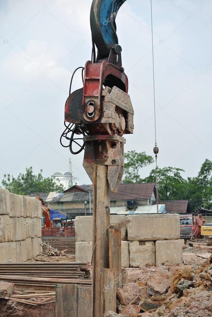 Retaining wall steel sheet pile installation by machine Stock Photo by ...