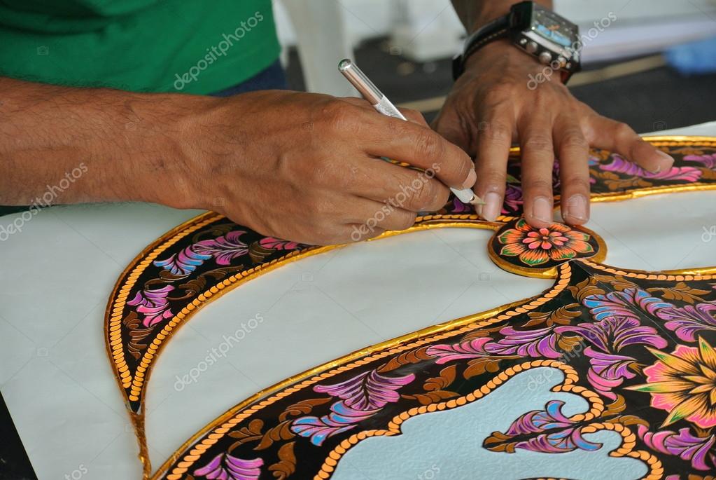 Malaysian kite maker working on a kite in his workshop Stock Photo by ...