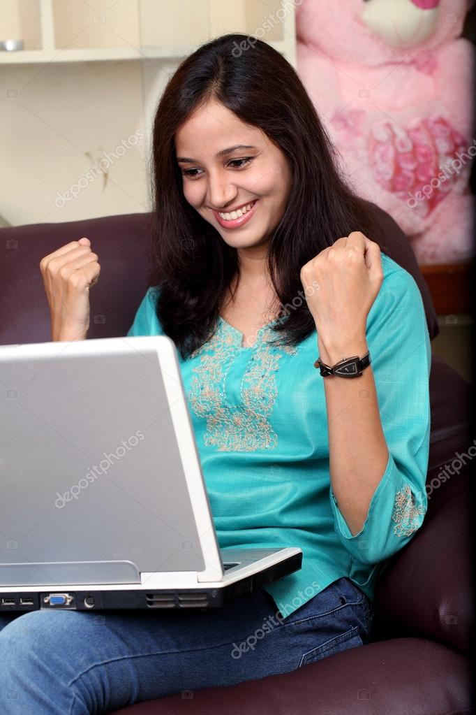 Excited woman with laptop Stock Photo by ©snowwhiteimages 81790614