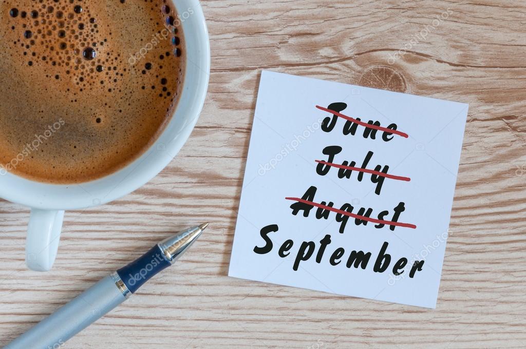 September beginning and summer end concept written at notepad with ...