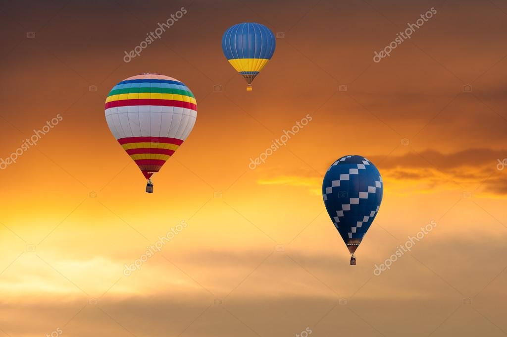 Three Hot Air Balloons in Flight on sunset sky background. Festival of ...