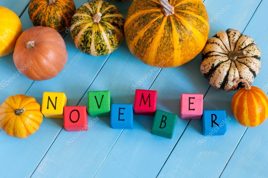 Word November On childs toy cubes and pumpkins on rural landscape ...