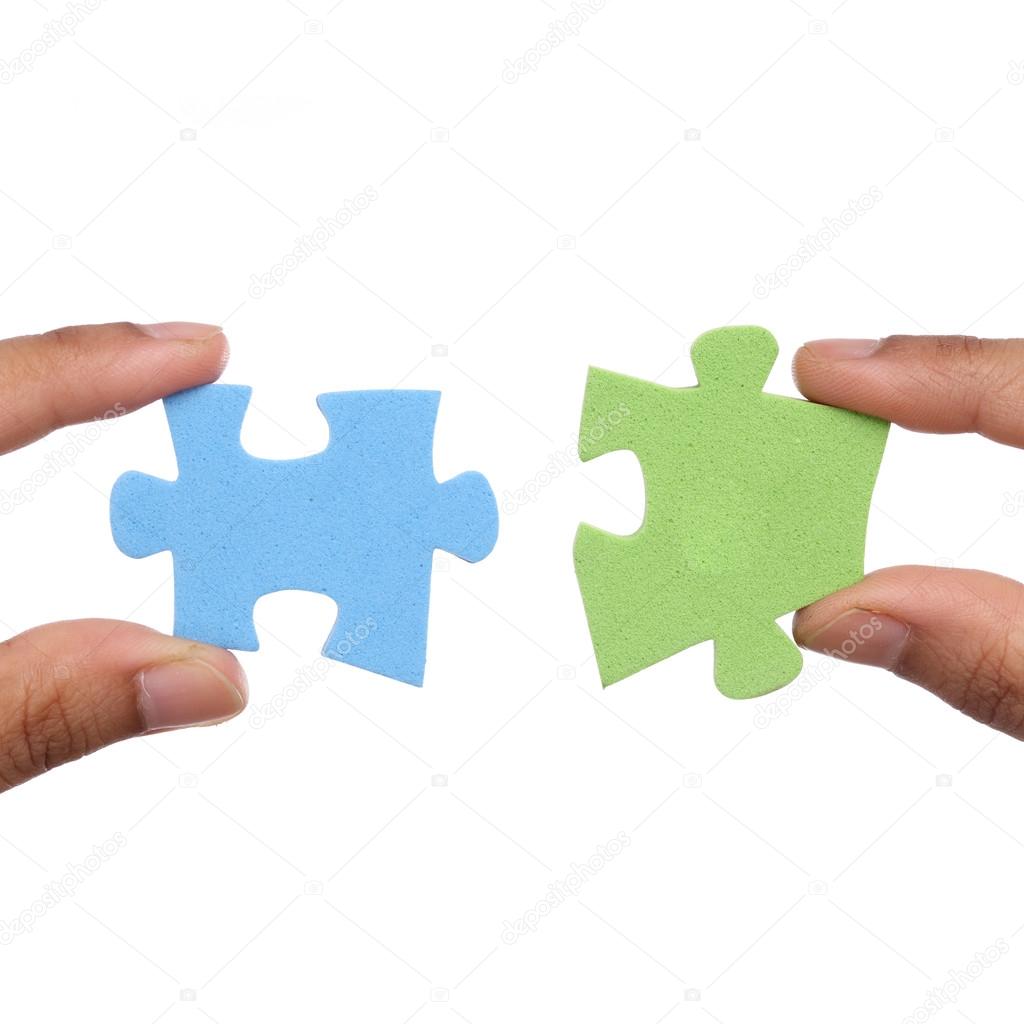 Two hands holding puzzle pieces and connecting them — Stock Photo ... Two hands holding puzzle pieces and connecting them — Stock Photo ...
