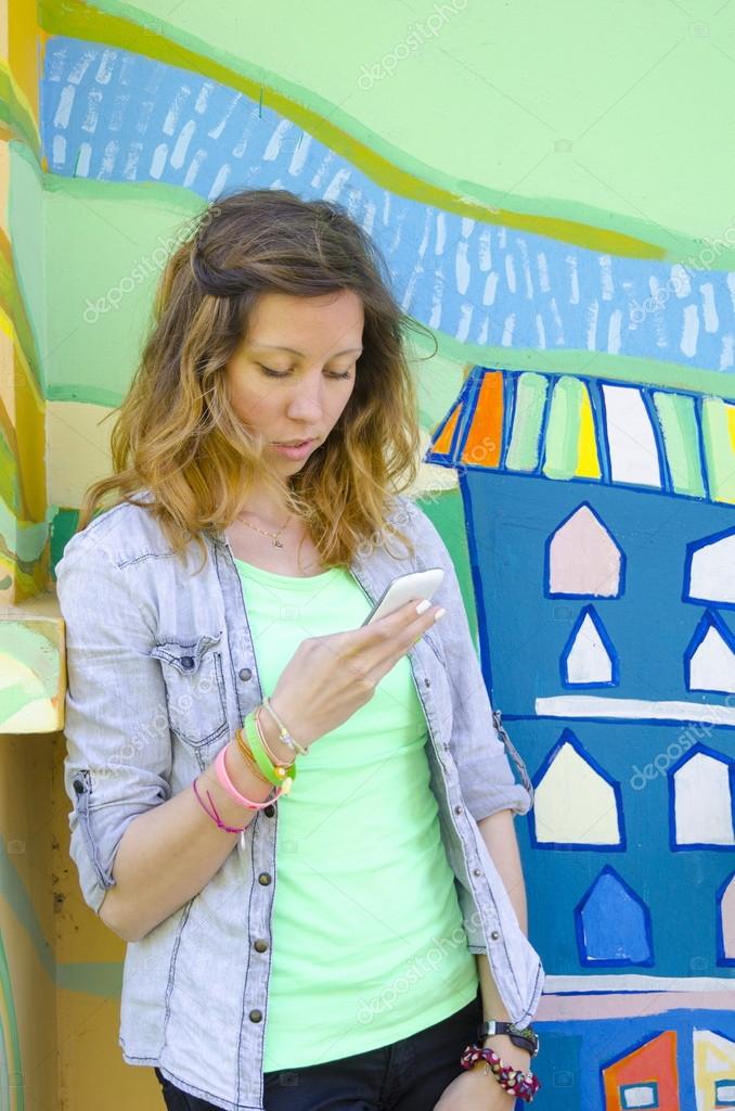 Girl reading a text message from her smart phone Stock Photo by ...