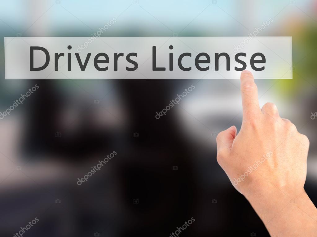 Drivers License - Hand pressing a button on blurred background c ...