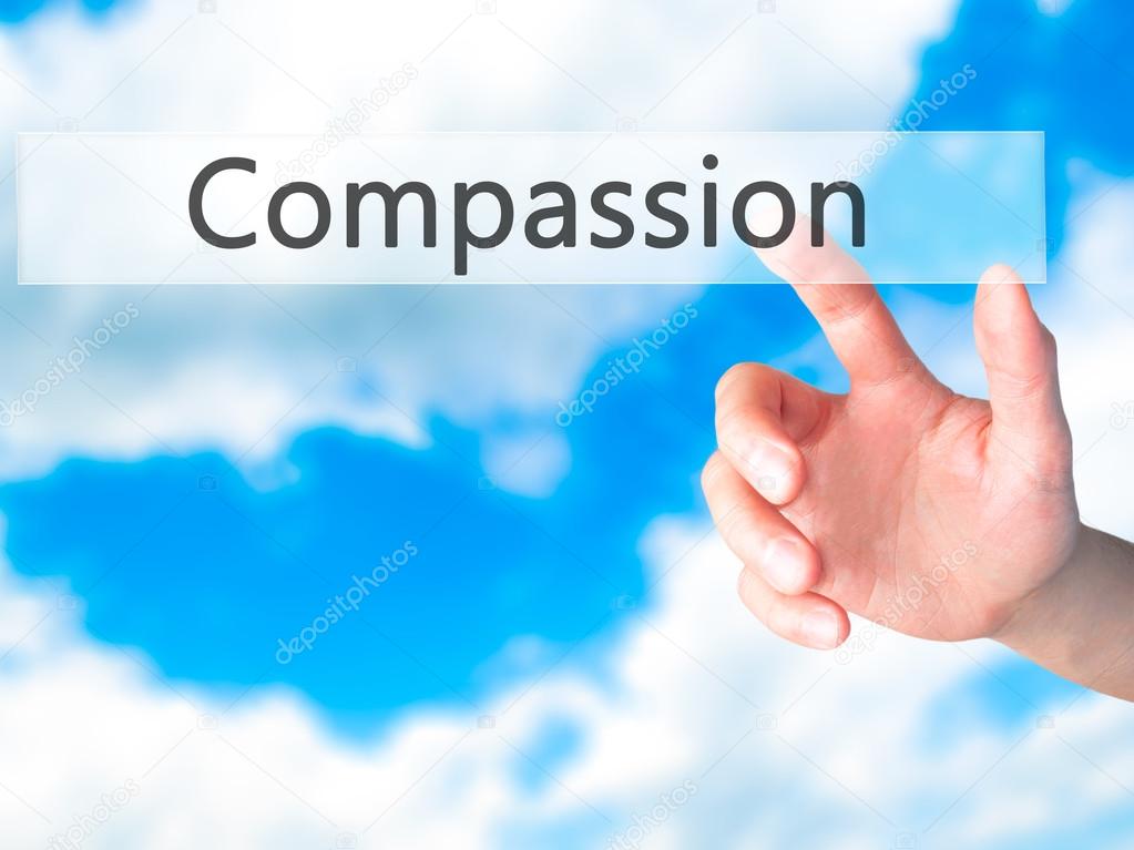 Compassion - Hand pressing a button on blurred background concep ...