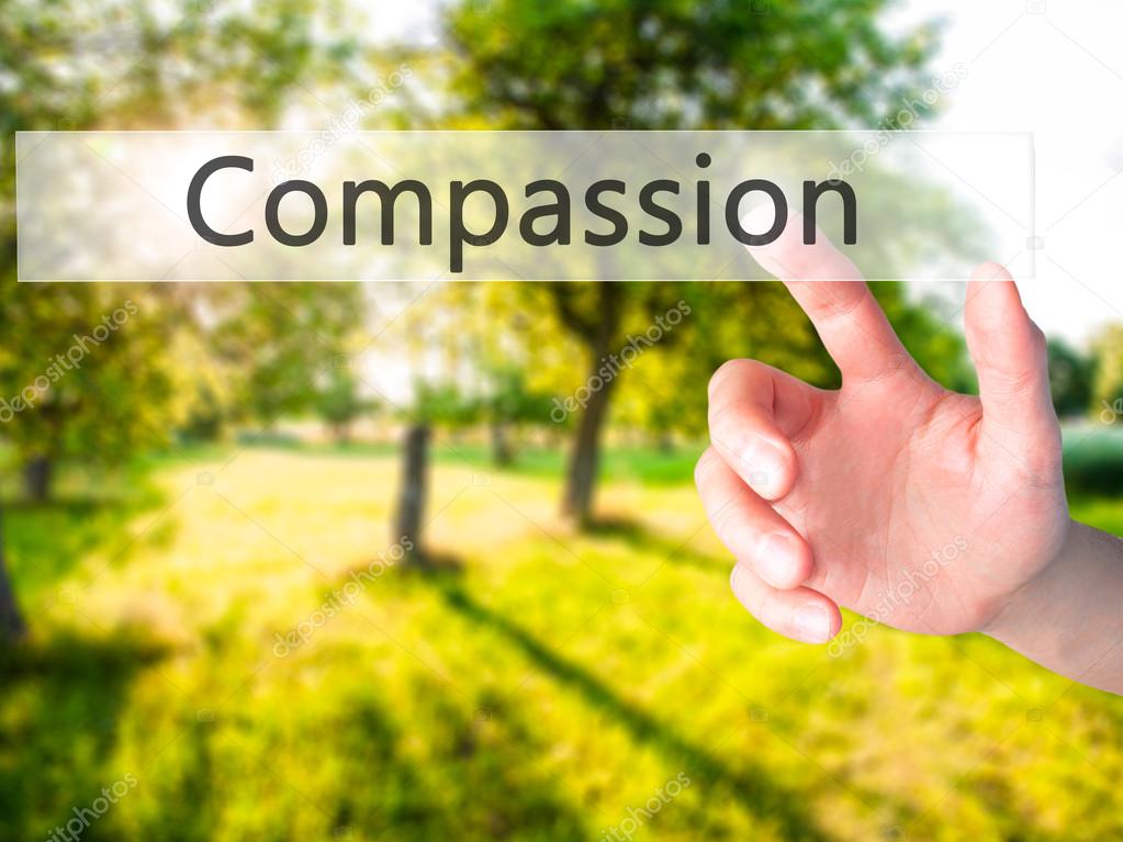 Compassion - Hand pressing a button on blurred background concep ...