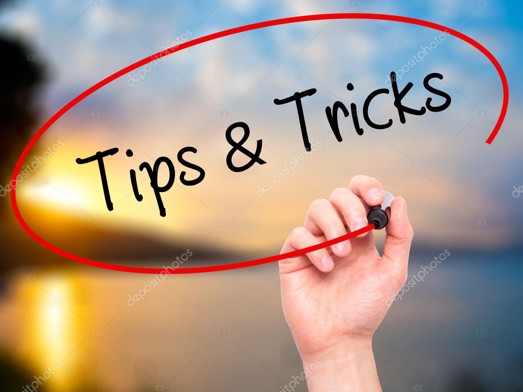 Man Hand writing Tips & Tricks with black marker on visual s — Stock ...