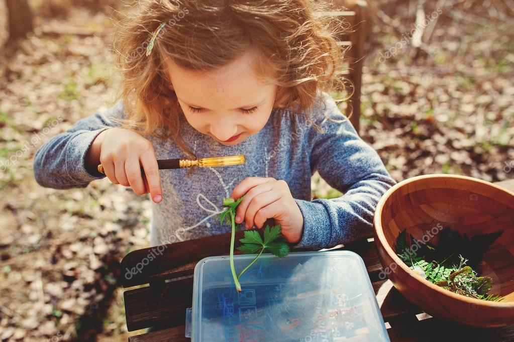 niña explorando la naturaleza a principios de primavera, mirando los ...