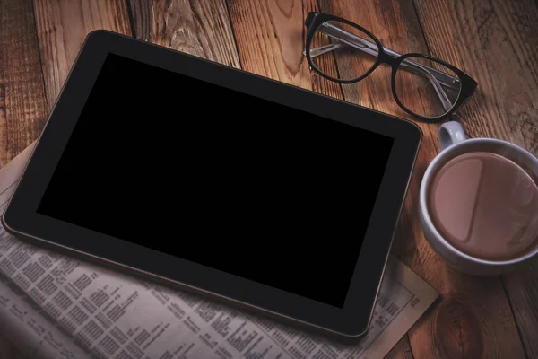 Tablet computer, coffe and newspaper on table - Stock Image - Everypixel
