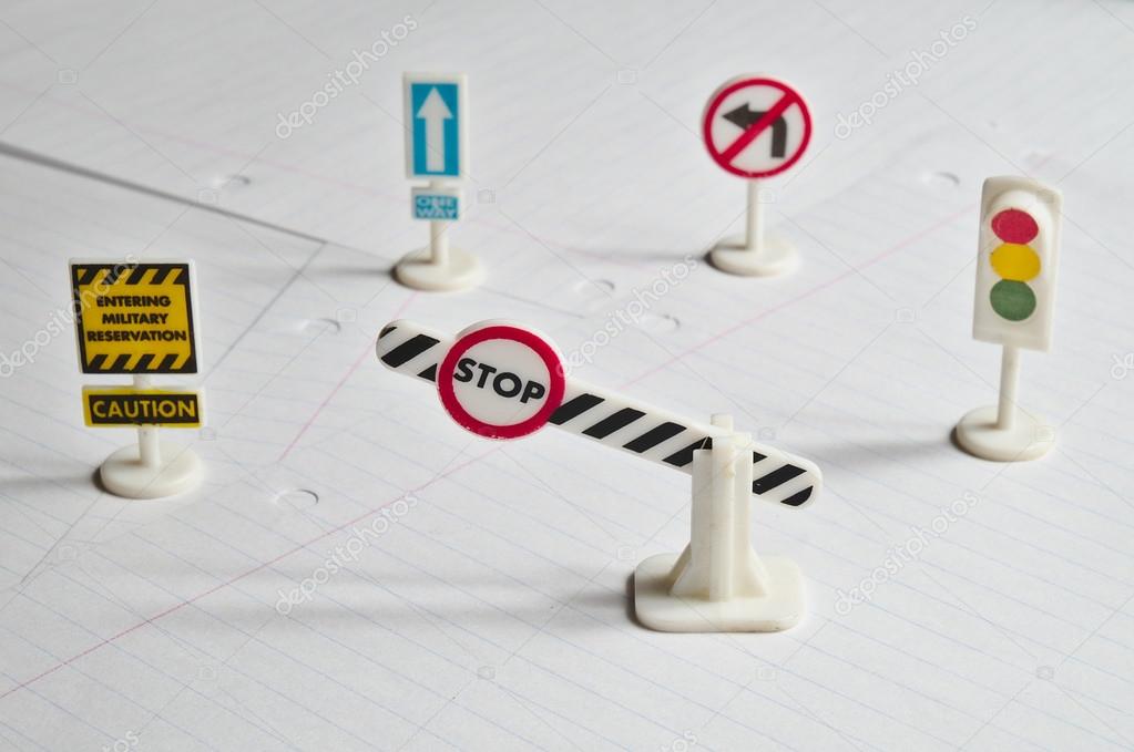 Several toy traffic signs on display on a blank sheet of paper — Stock ...